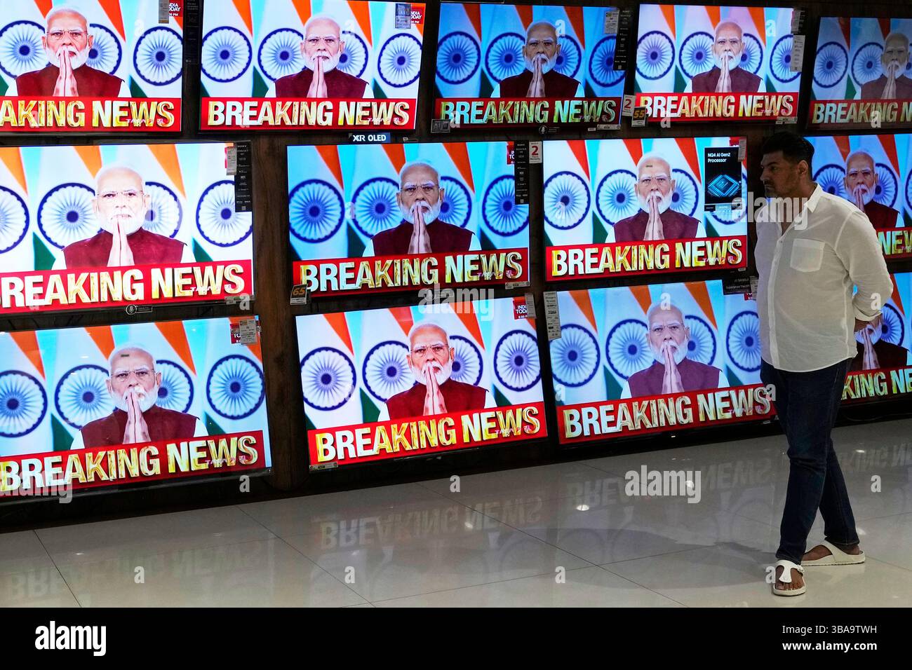 A man watches the live telecast of Indian Prime Minister Narendra Modi ...