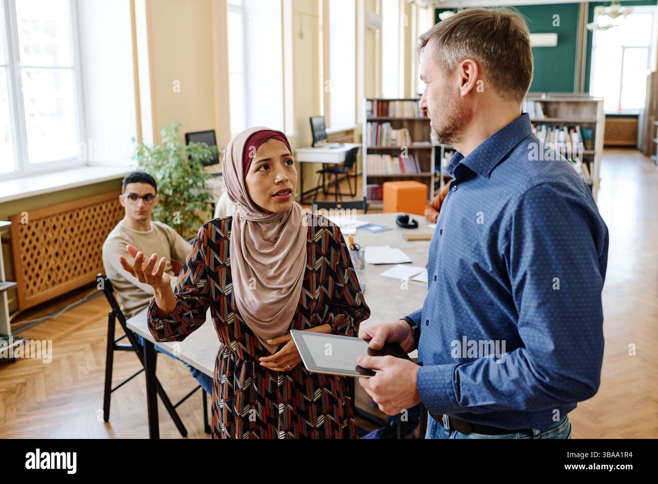 Young Muslim woman wearing hijab telling poem by heart during English ...