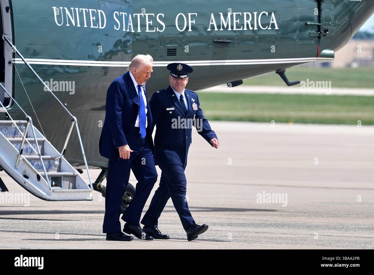 President Donald Trump walks with Col. Paul Pawluk, Vice Commander of ...