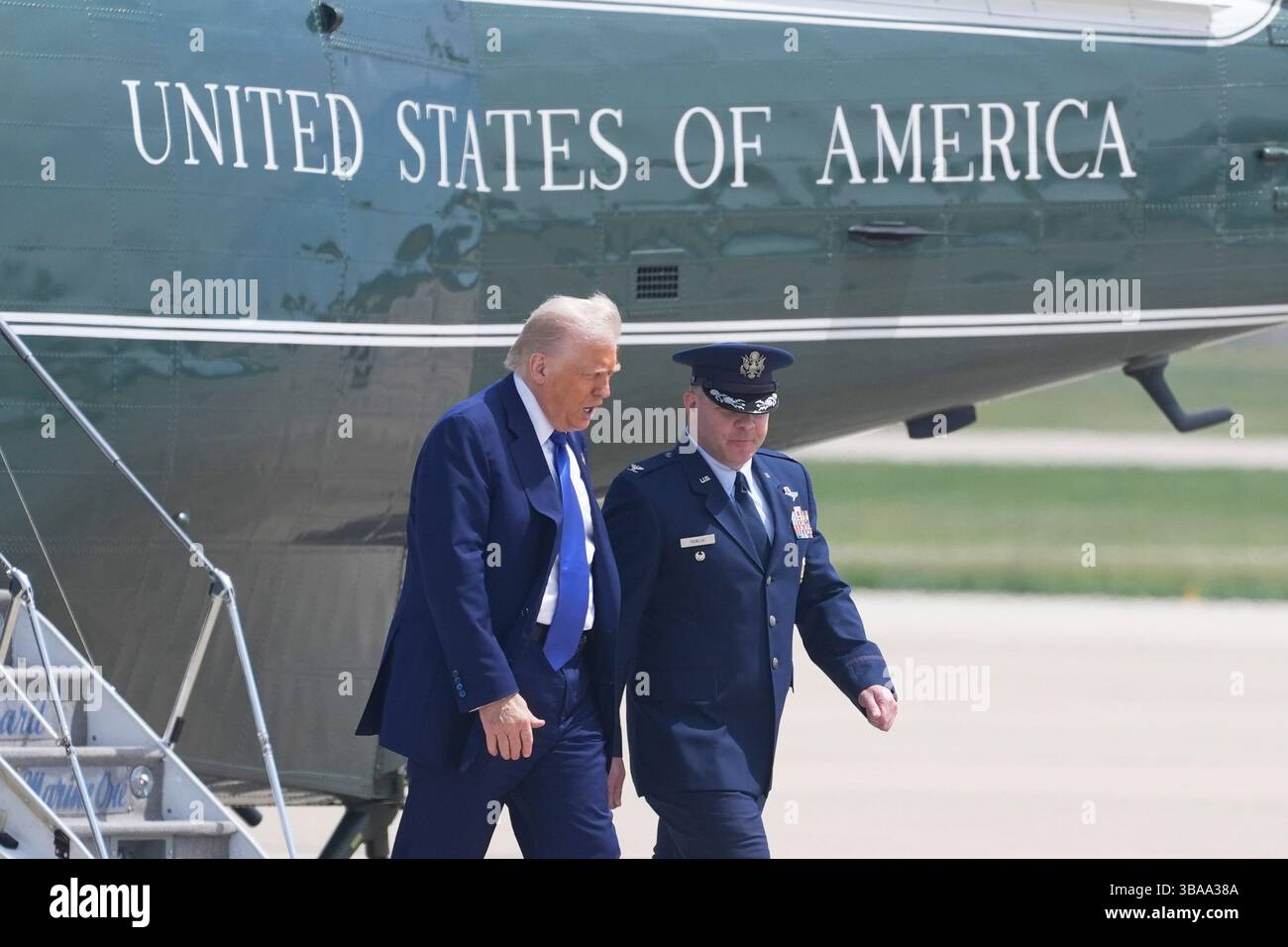 President Donald Trump walks with Col. Paul Pawluk, Vice Commander of ...