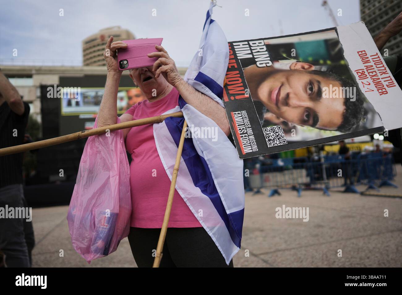 A man holds a placard of Israeli-American soldier Edan Alexander as he ...