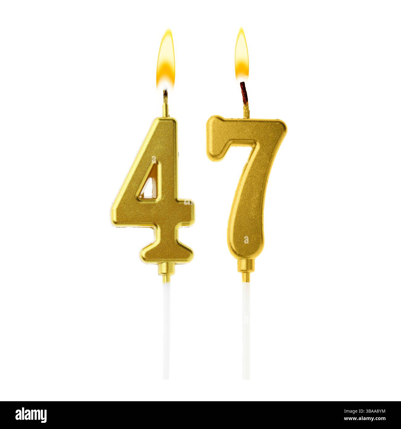 Burning golden cake candles composing number 47 on white background ...