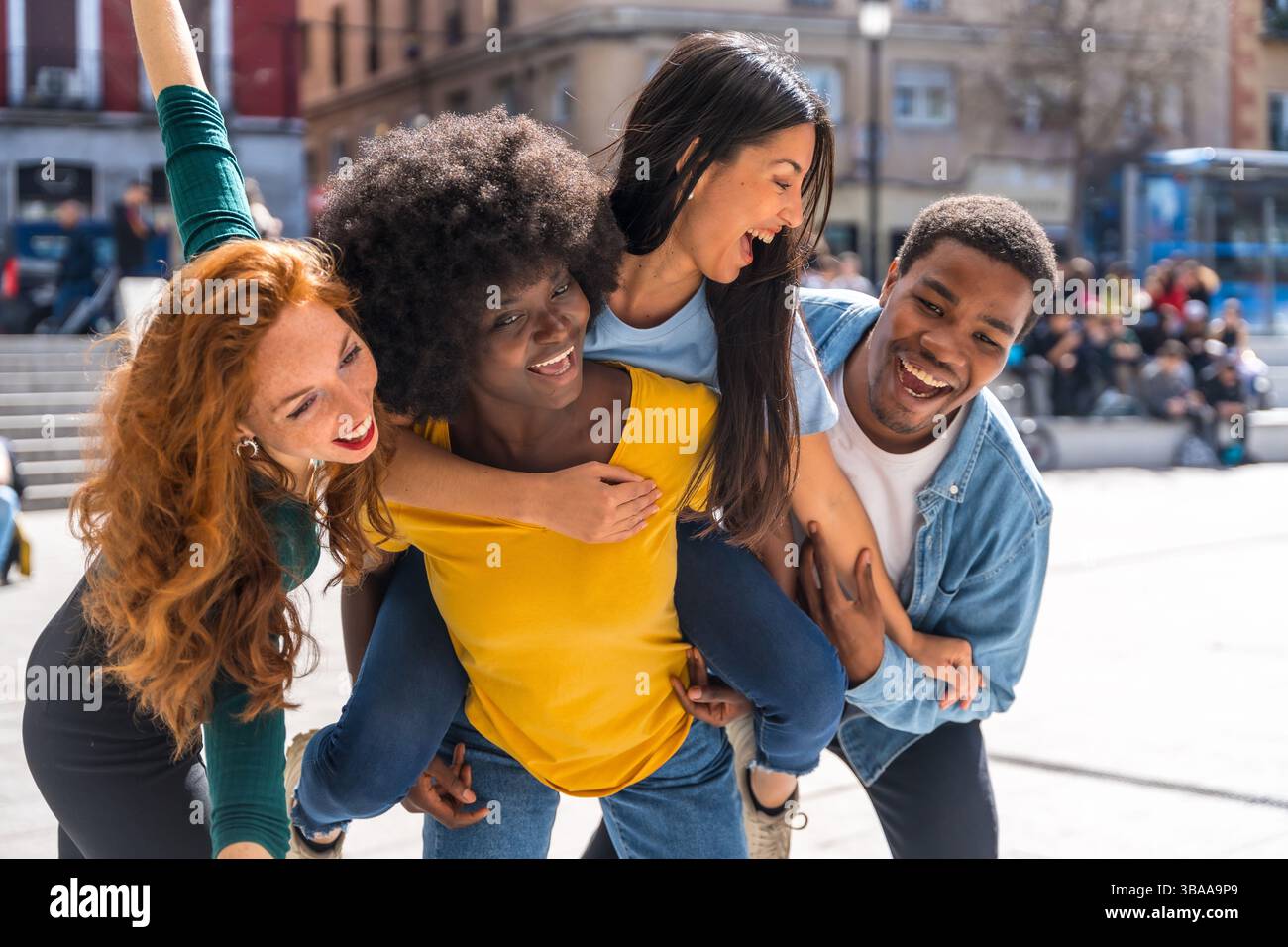 Black woman giving piggyback ride to female friend having fun with ...