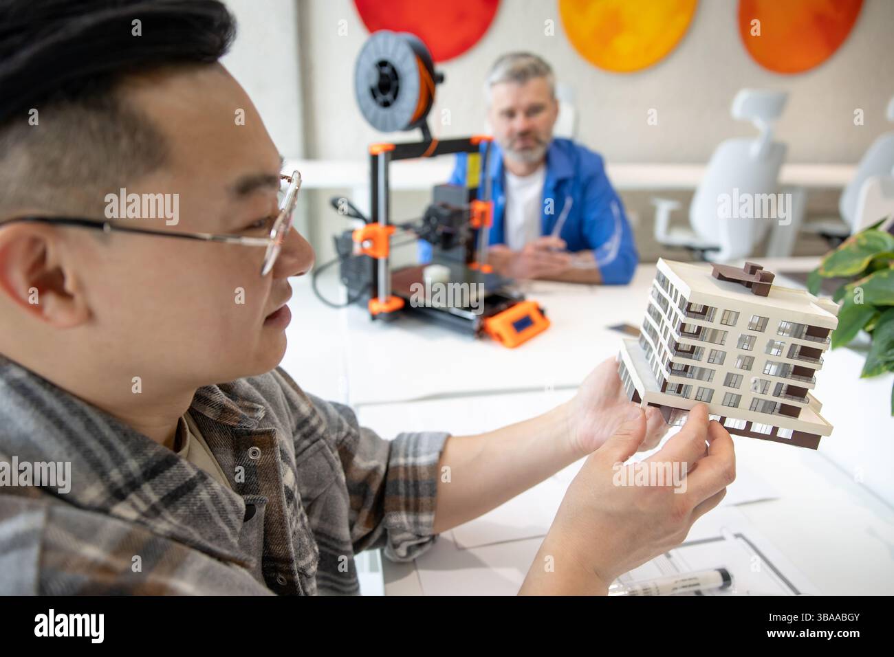 Team of architects making house model working with 3D printer, creating ...