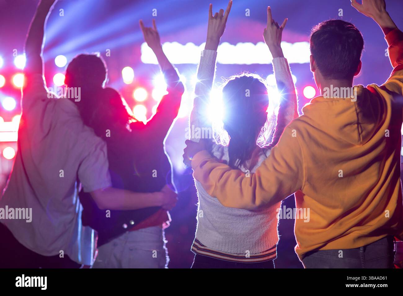 Group of Chinese couples hugging each other raising arms standing at ...