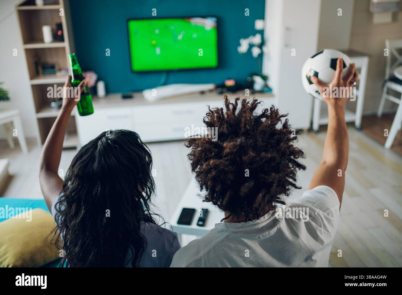 African american sports fan couple watching important soccer match on ...