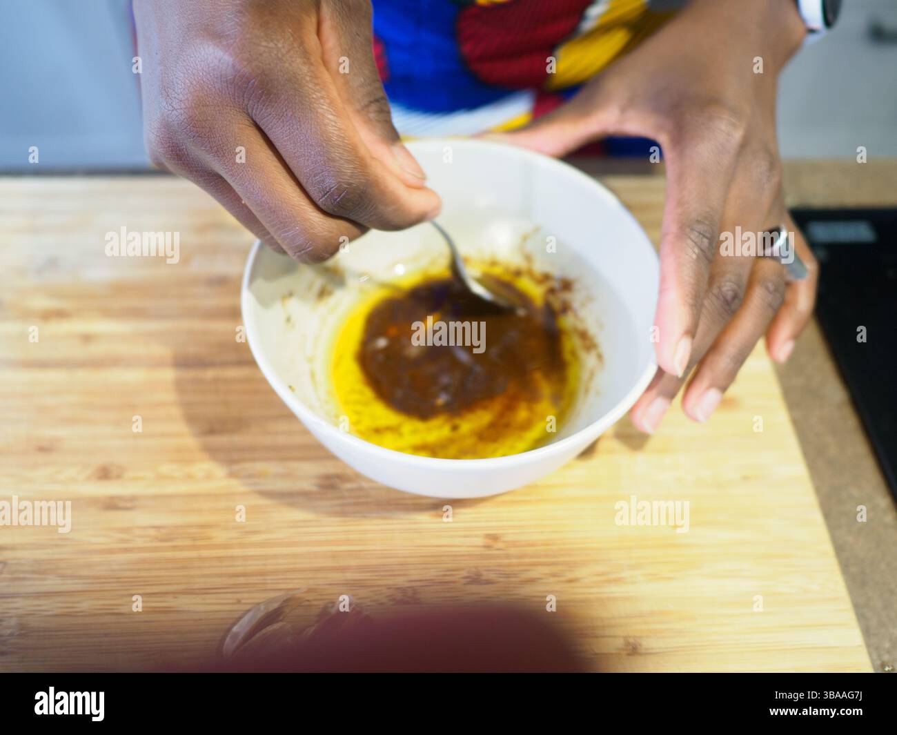 Hands of Black woman making sauce in kitchen counter at home Stock ...