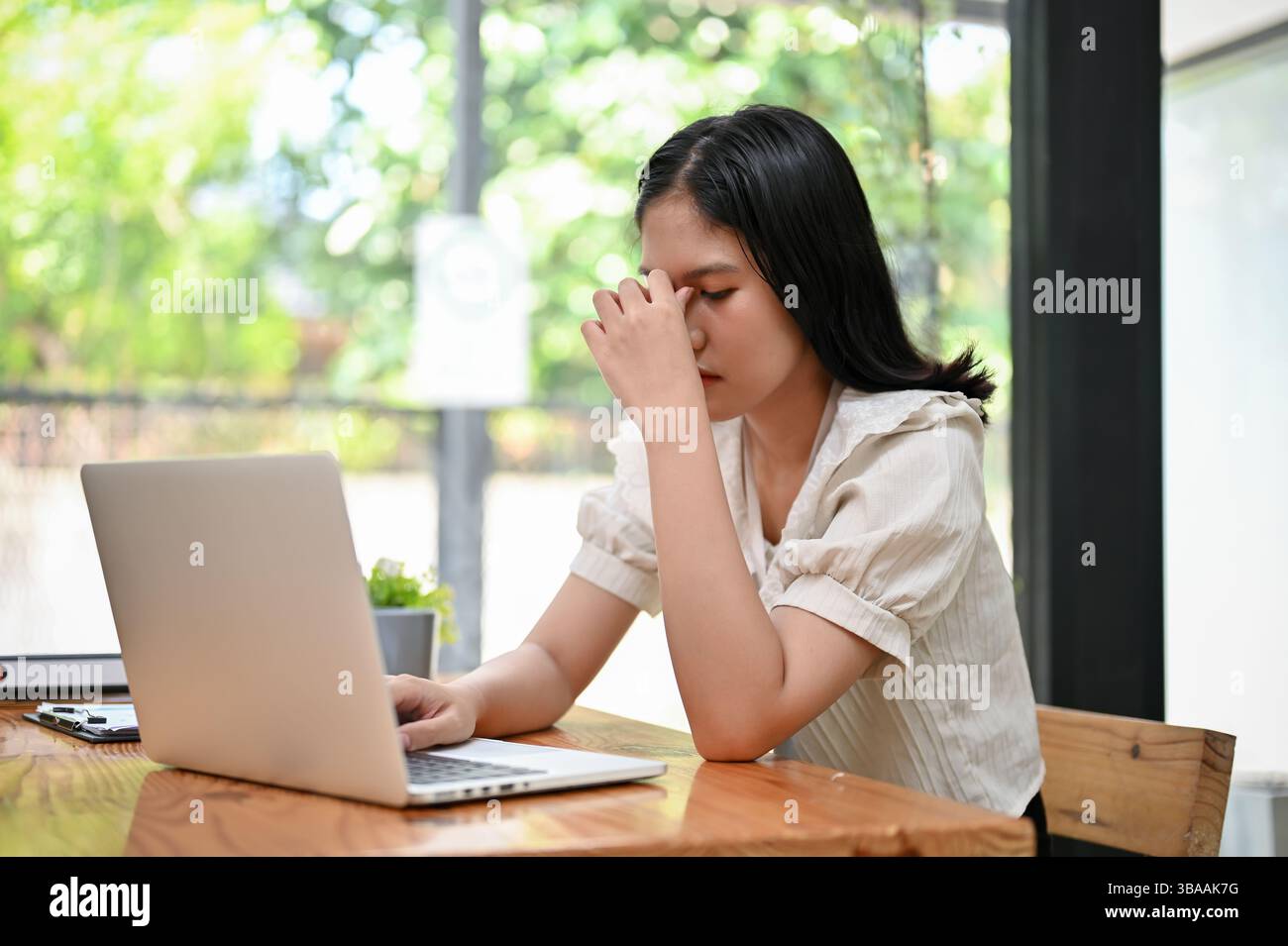 Stressed and upset young asian female office worker upset with herself ...