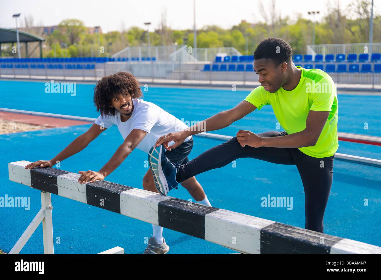 Two young african american sportsmen talking distracted while ...