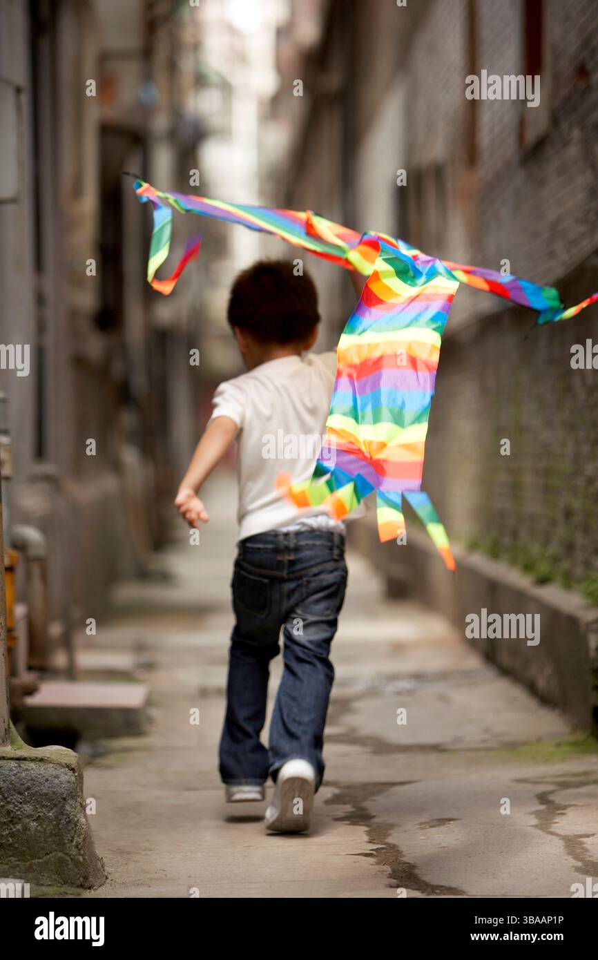 Chinese child running with a kite Stock Photo - Alamy