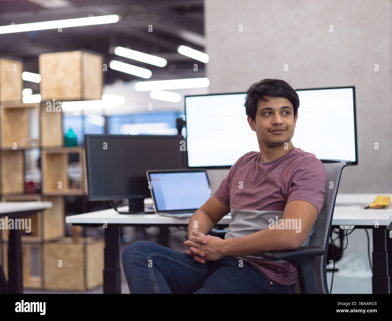 Portrait of young indian successful male software developer sitting on ...