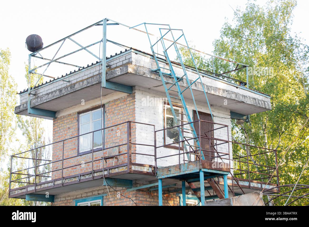 Observation two-story building brick building with stairs and balcony ...