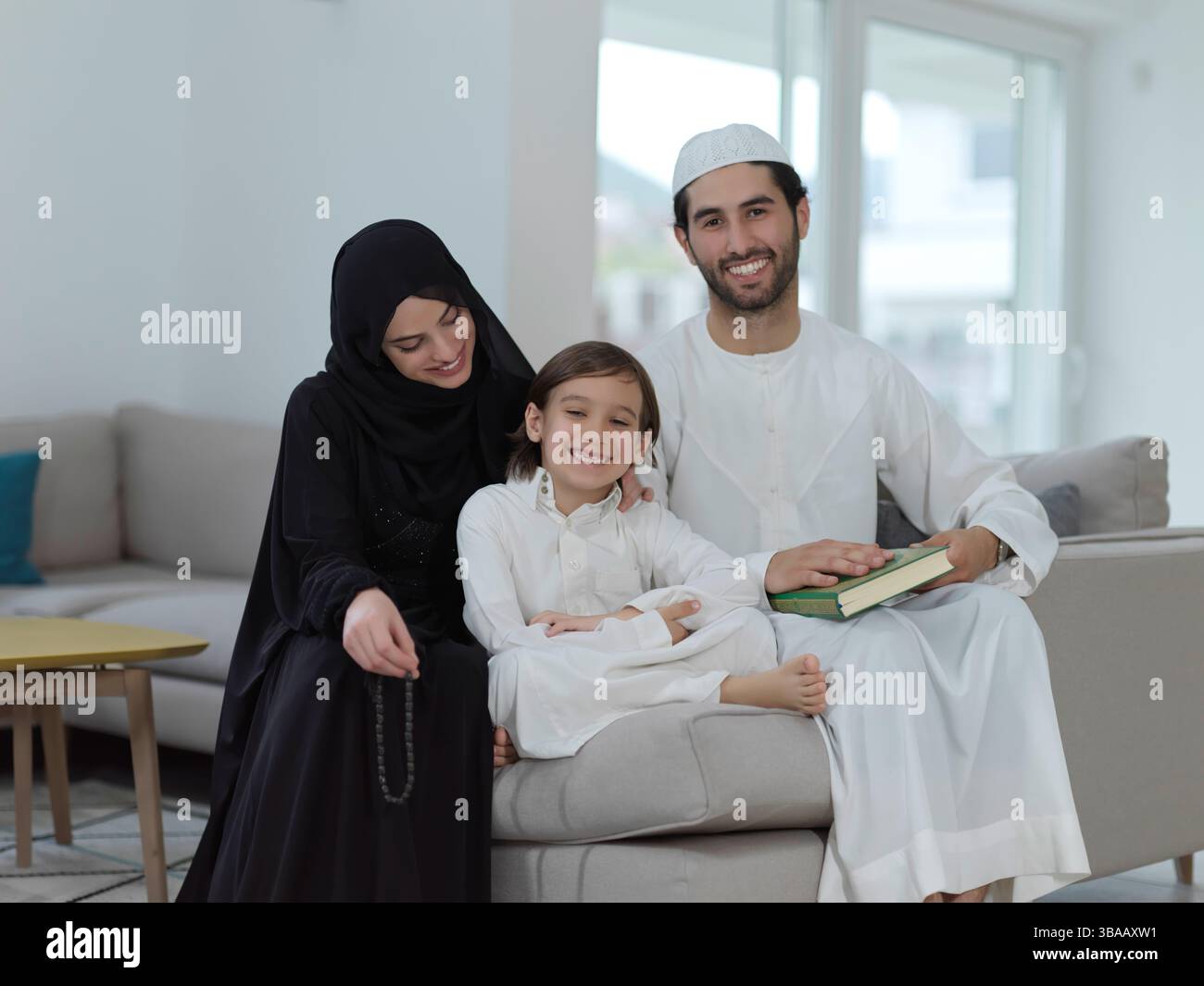 Young muslim family reading Quran during Ramadan. Parents and son ...