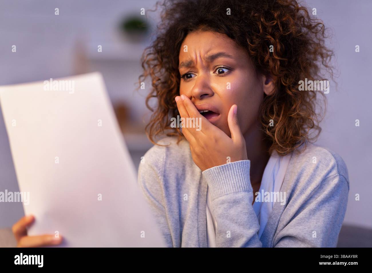 Shocked woman reading unexpected letter from husband, girl covering ...