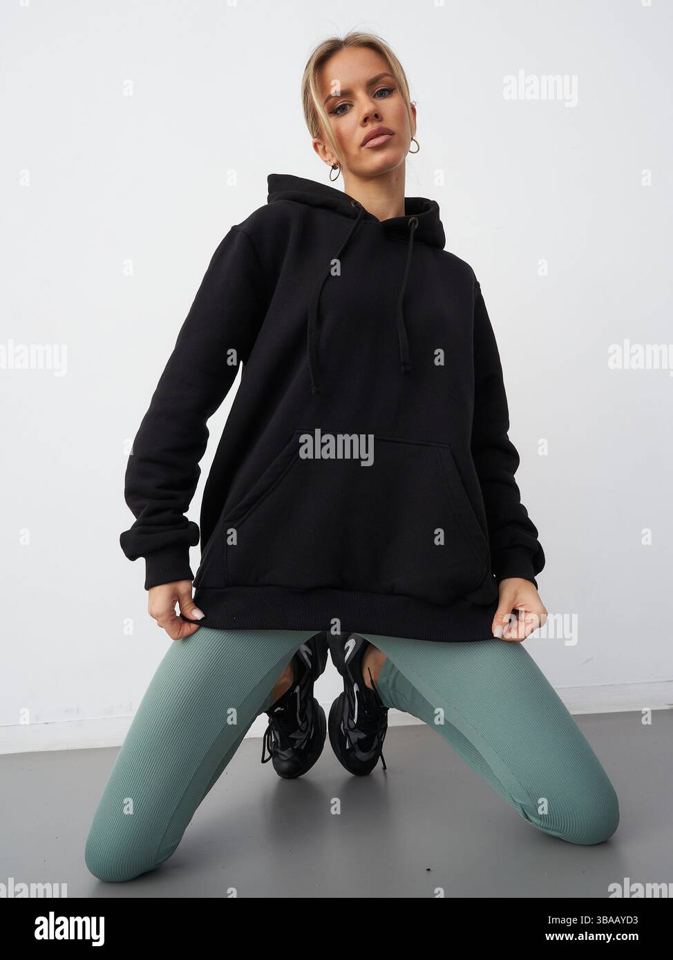 Stylish female model poses confidently in a modern studio wearing ...