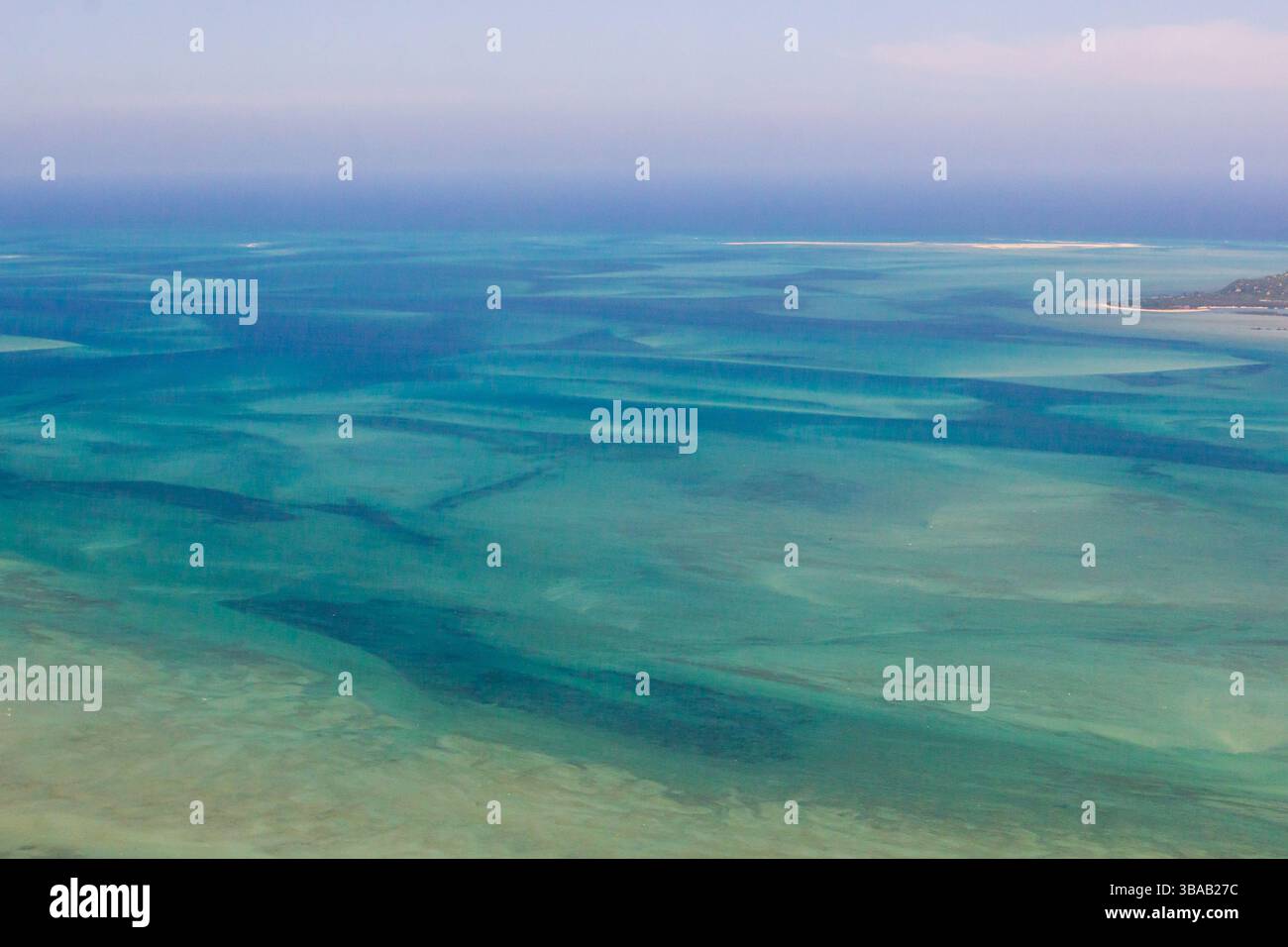 Aerial view of the shallow ocean with its submerged sandbars and tidal ...