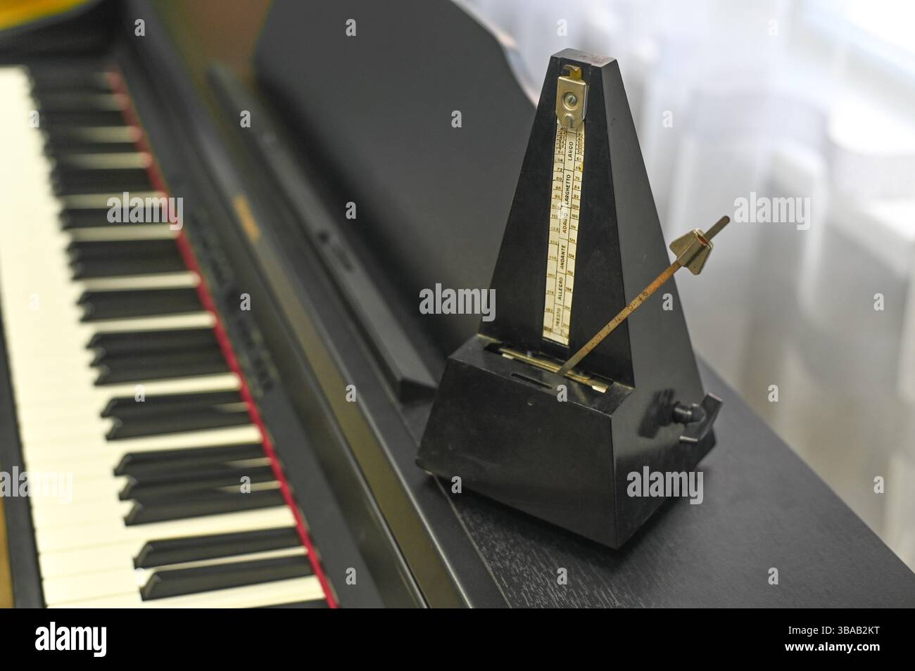 Mechanical metronome on modern electronic piano, symbolizing precision ...