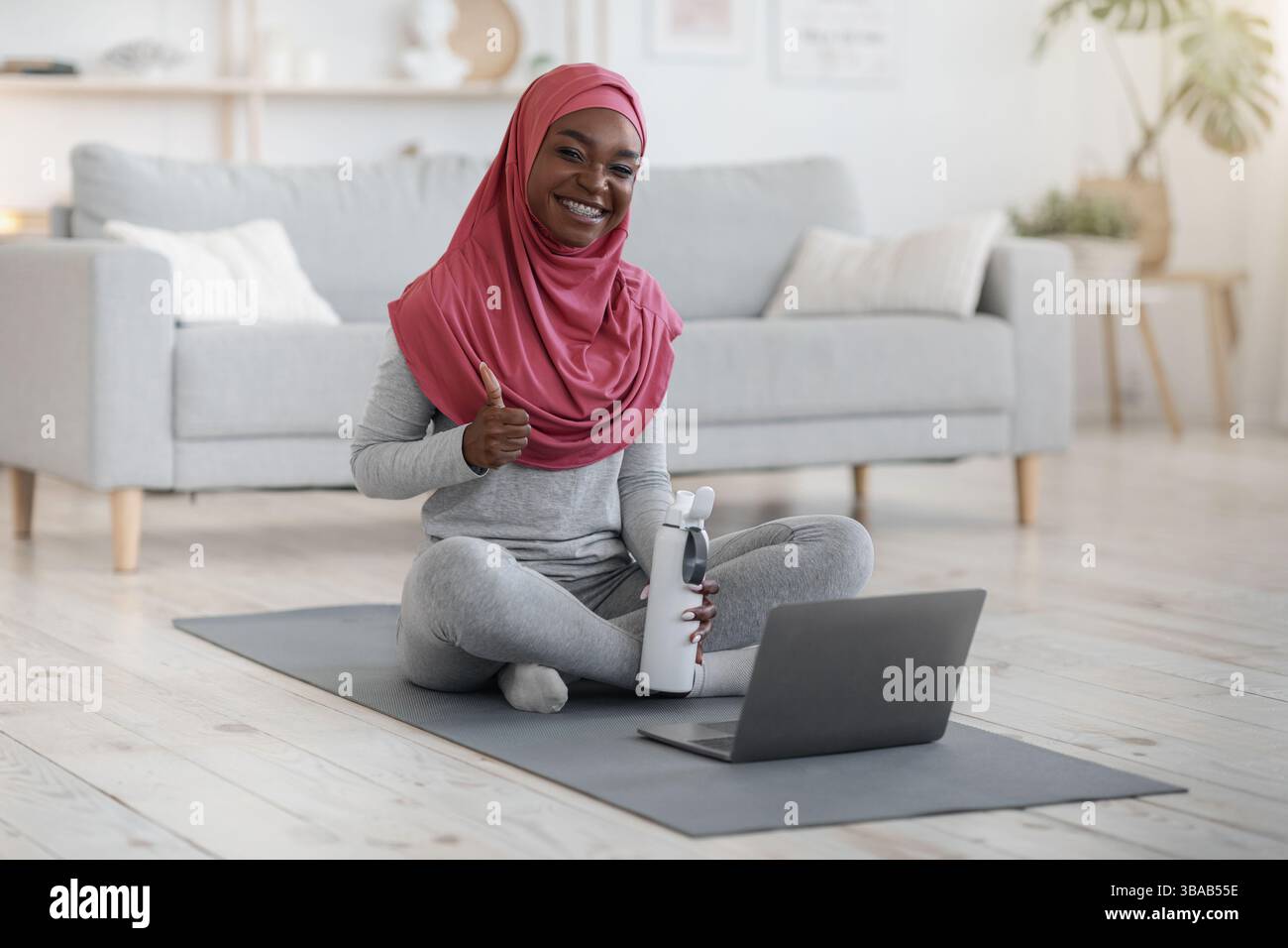 Happy Black Muslim Woman In Hijab Relaxing After Workout Training At ...