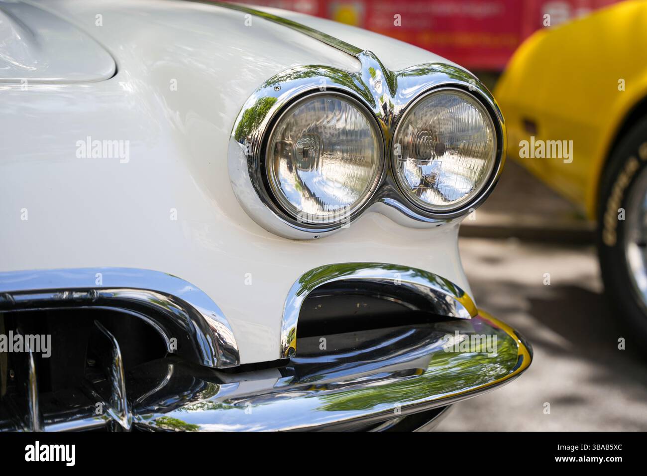 Front end of white vintage car with twin round headlights. Close-up of ...