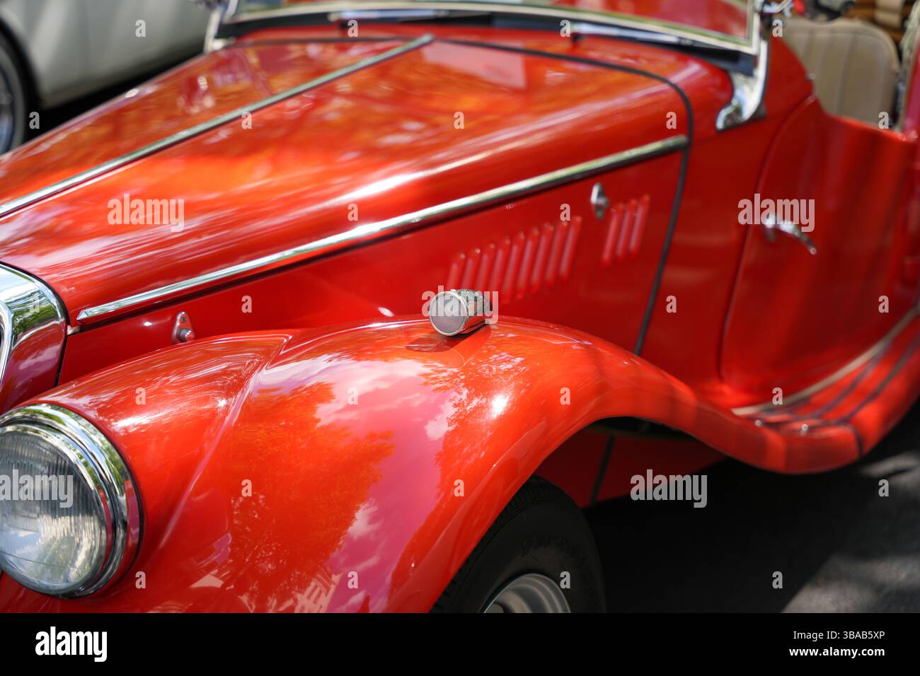 Red vintage roadster with rounded fender light. Bright red vintage ...