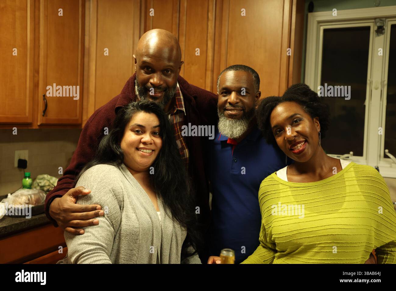 Black husbands with their wives standing in kitchen at home Stock Photo ...