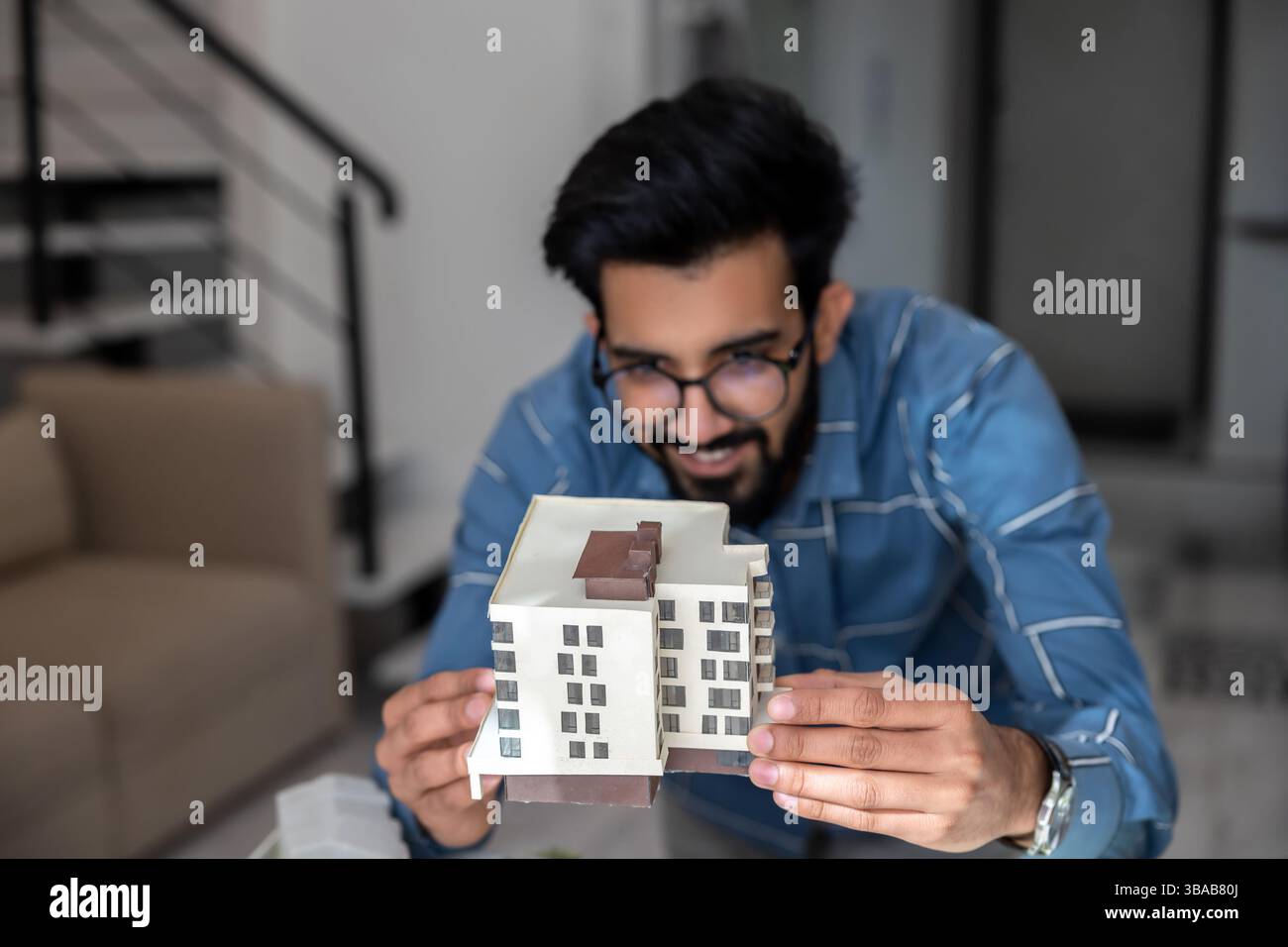 House mock up. Young engineer looking busy and involved while preparing ...