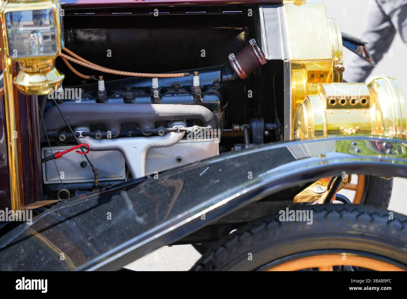 Vintage car engine compartment. An exposed vintage car engine with ...