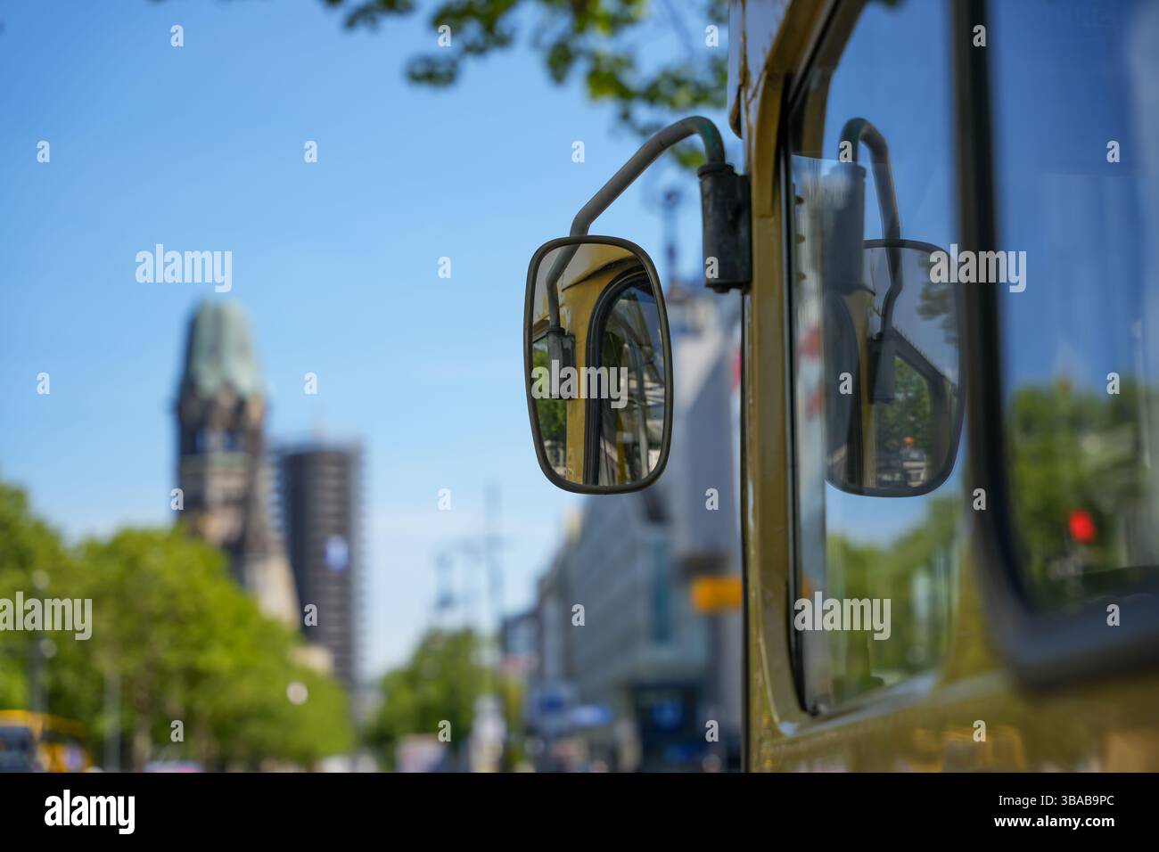 Mirror reflection on city street. Side mirror of a vintage bus ...