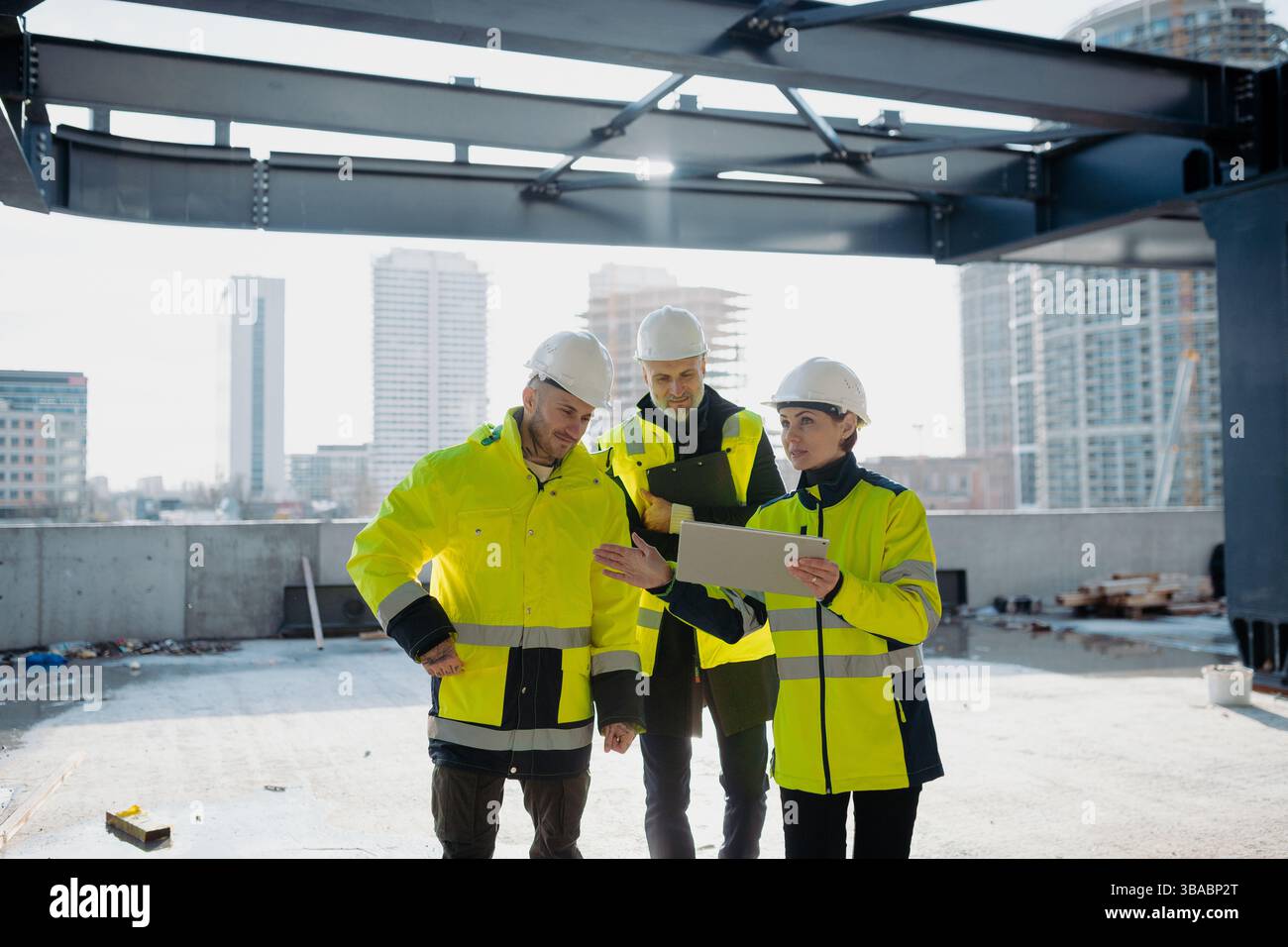 Team of engineers and construction workers inspecting building progress ...