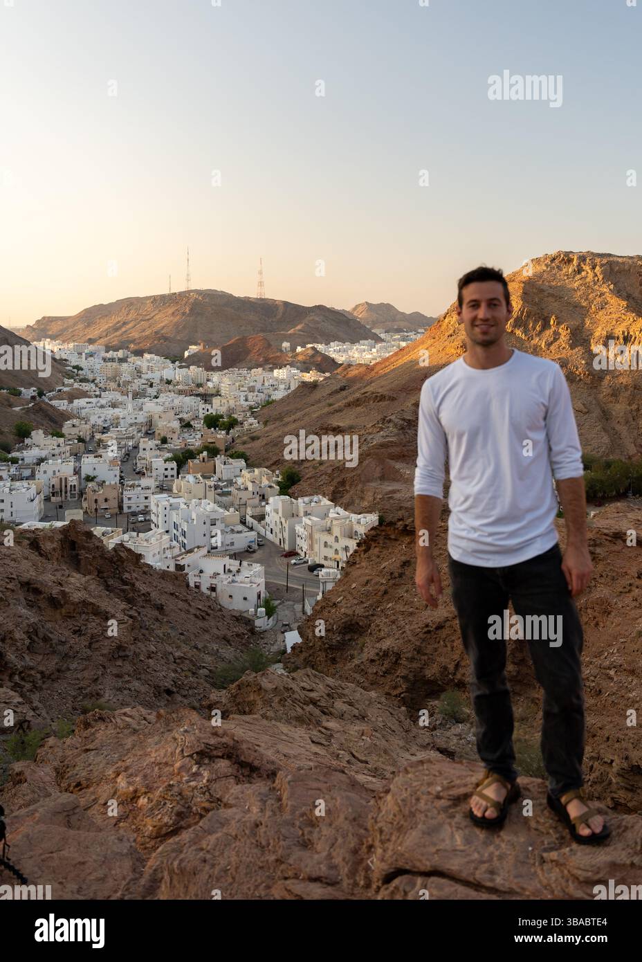 A man stands at the Yiti Round Point of View in Oman, gazing out at the ...