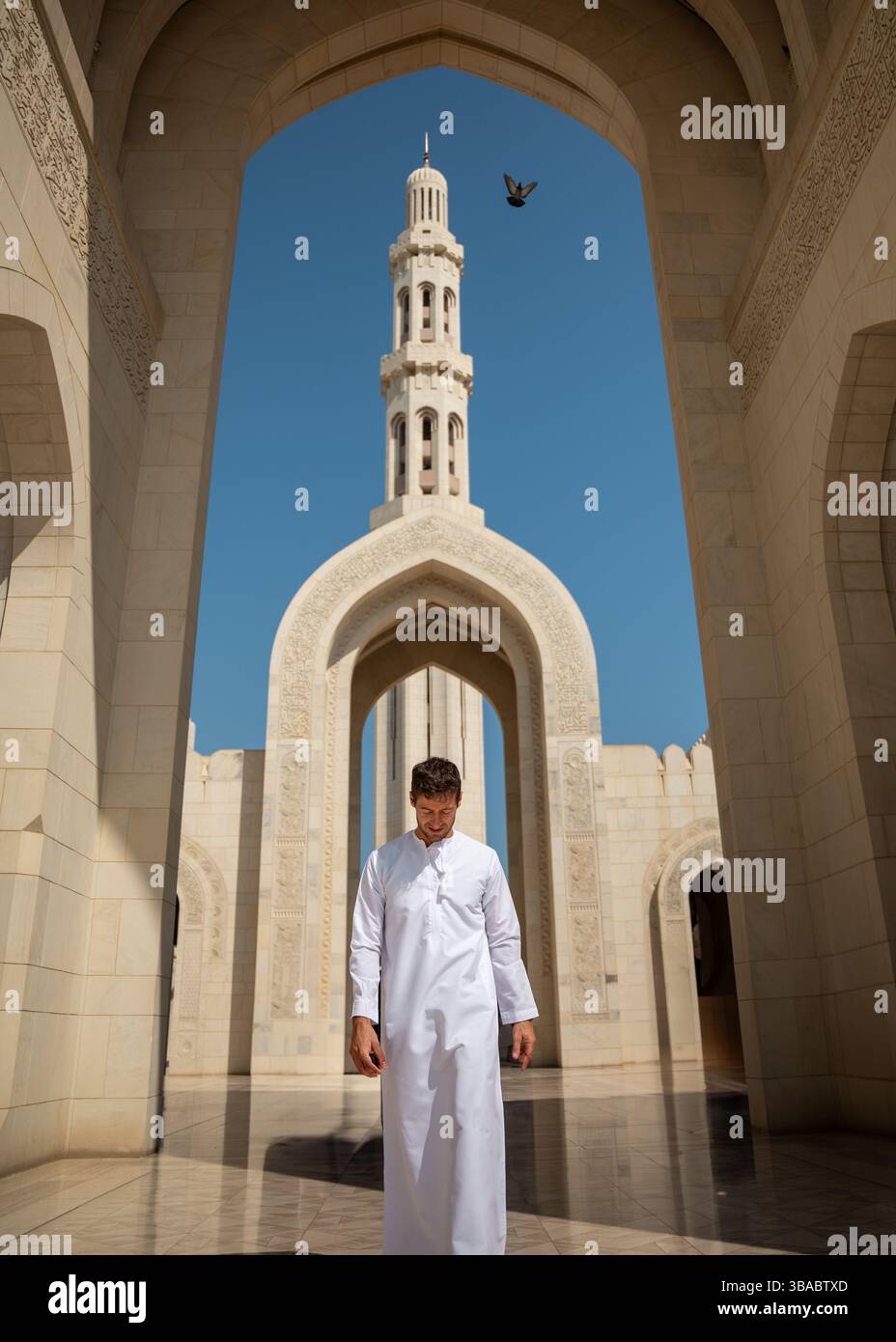 A man dressed in a traditional dishdasha walks through the stunning ...