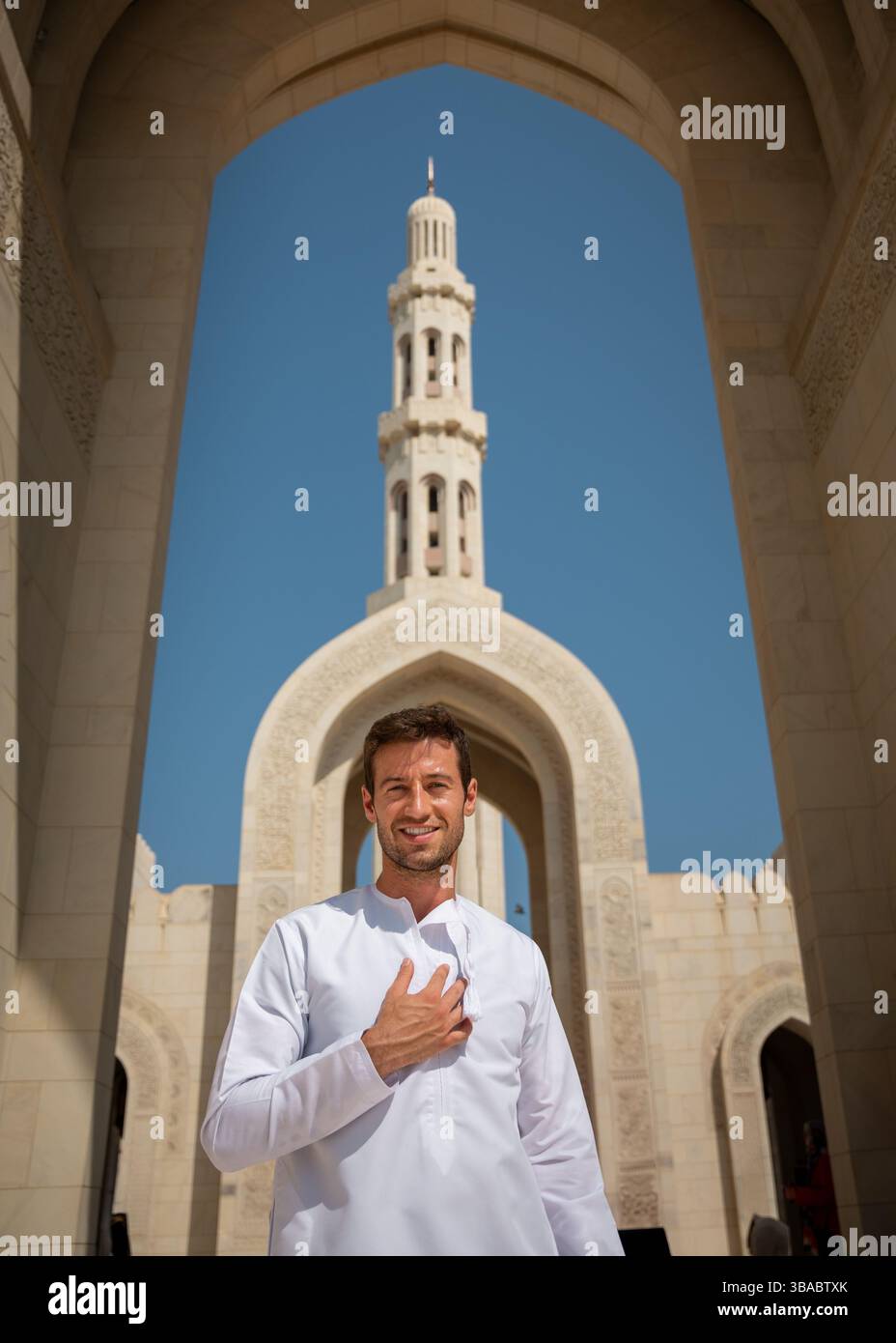 A man dressed in a traditional dishdasha walks through the stunning ...