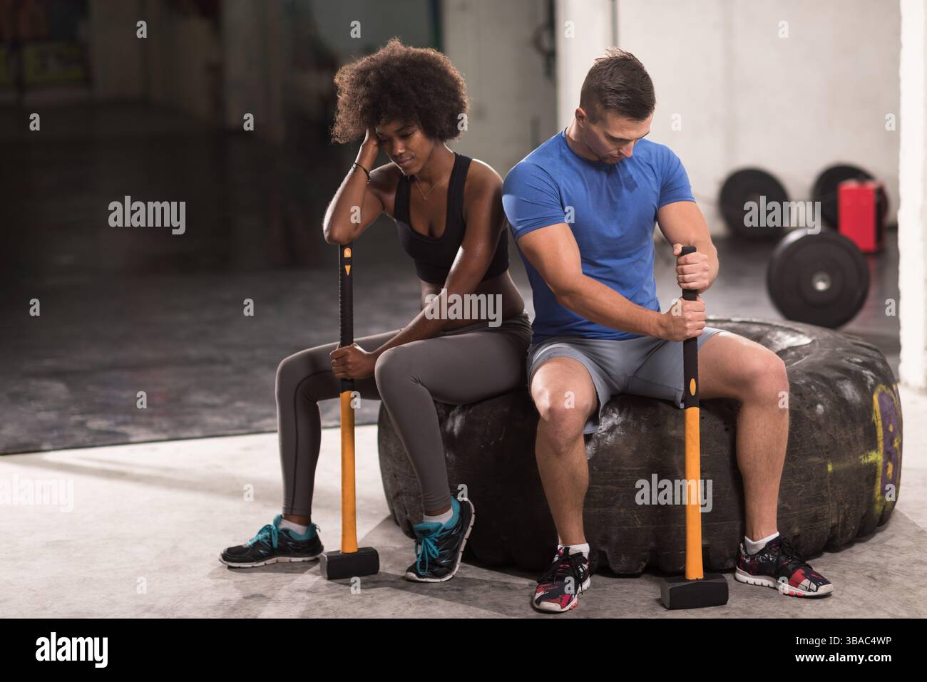 Sad Black woman with afro and caucasian boyfriend wearing fitness ...