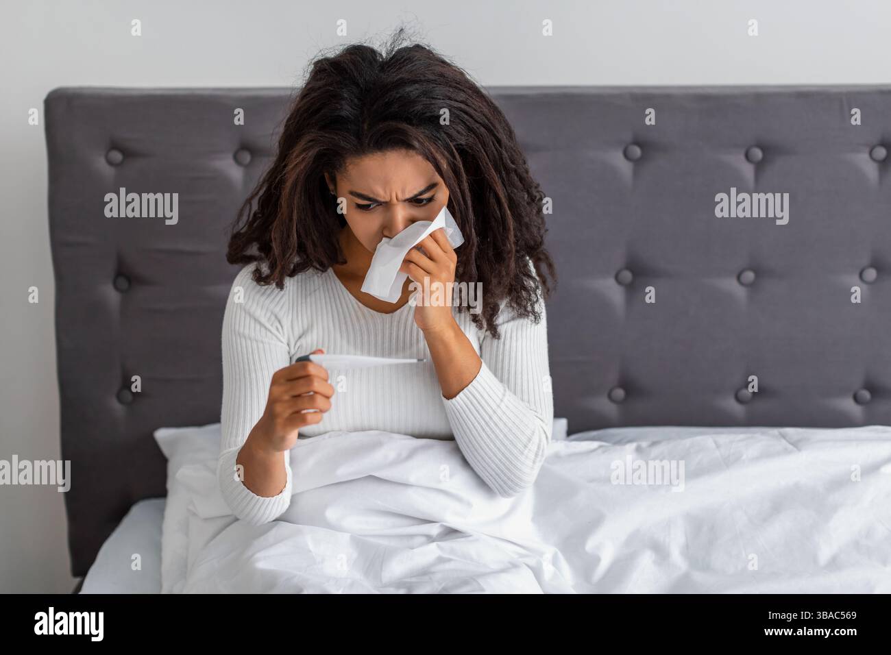 Sick black woman suffering from running stuffy nose and sore throat ...