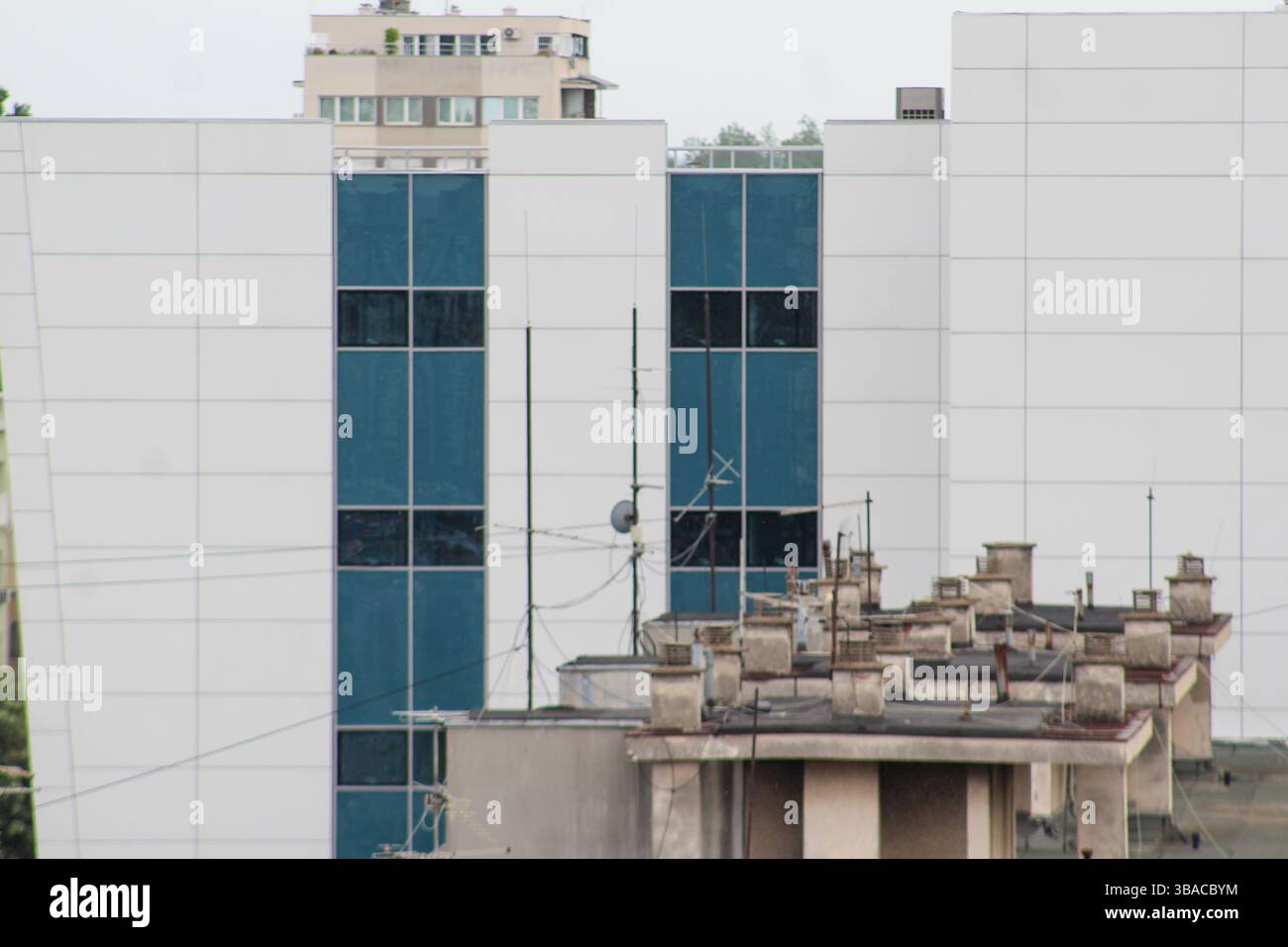 A striking contrast between a modern glass office building and old ...