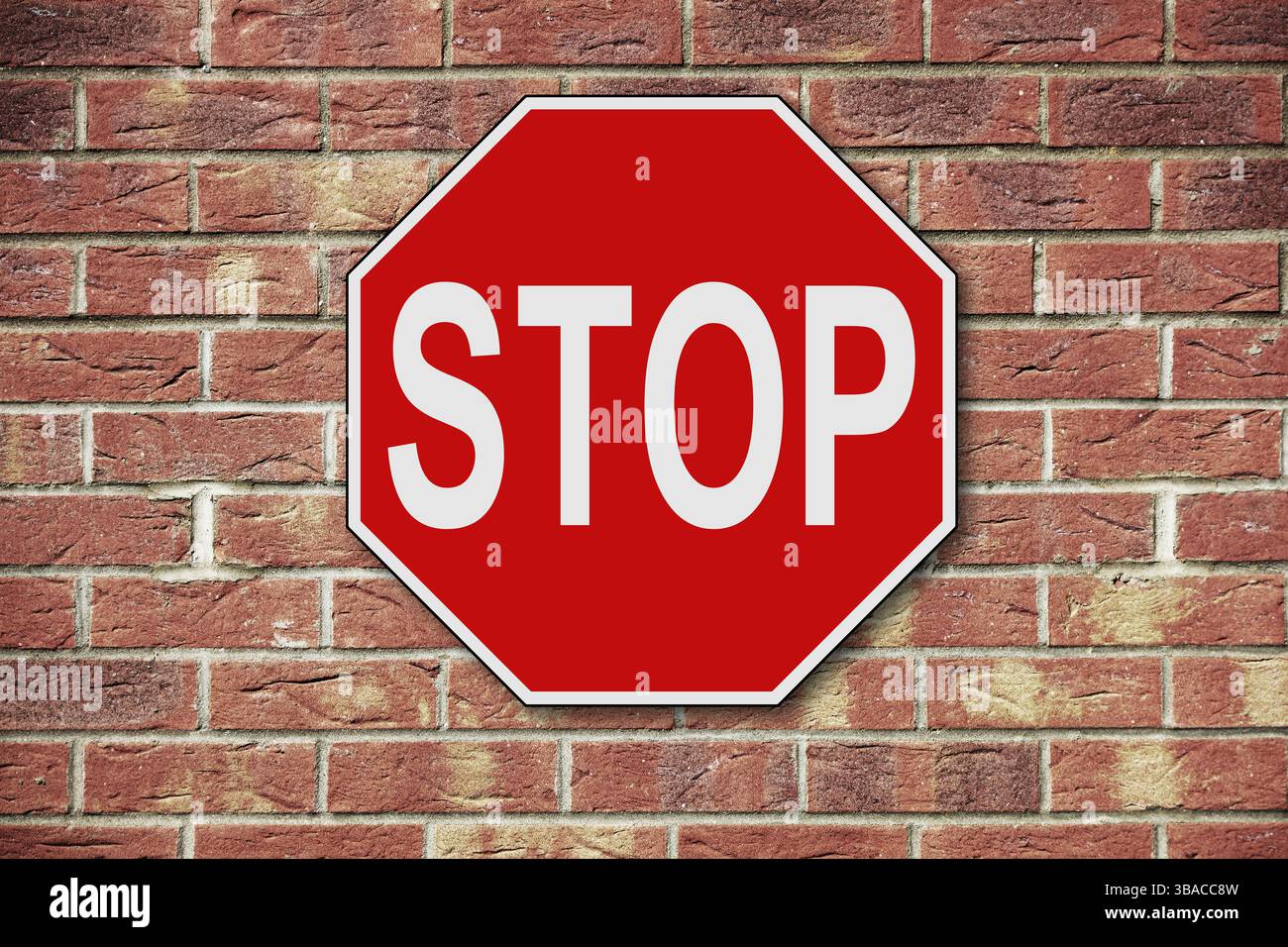 Stop sign on brick wall background Stock Photo - Alamy