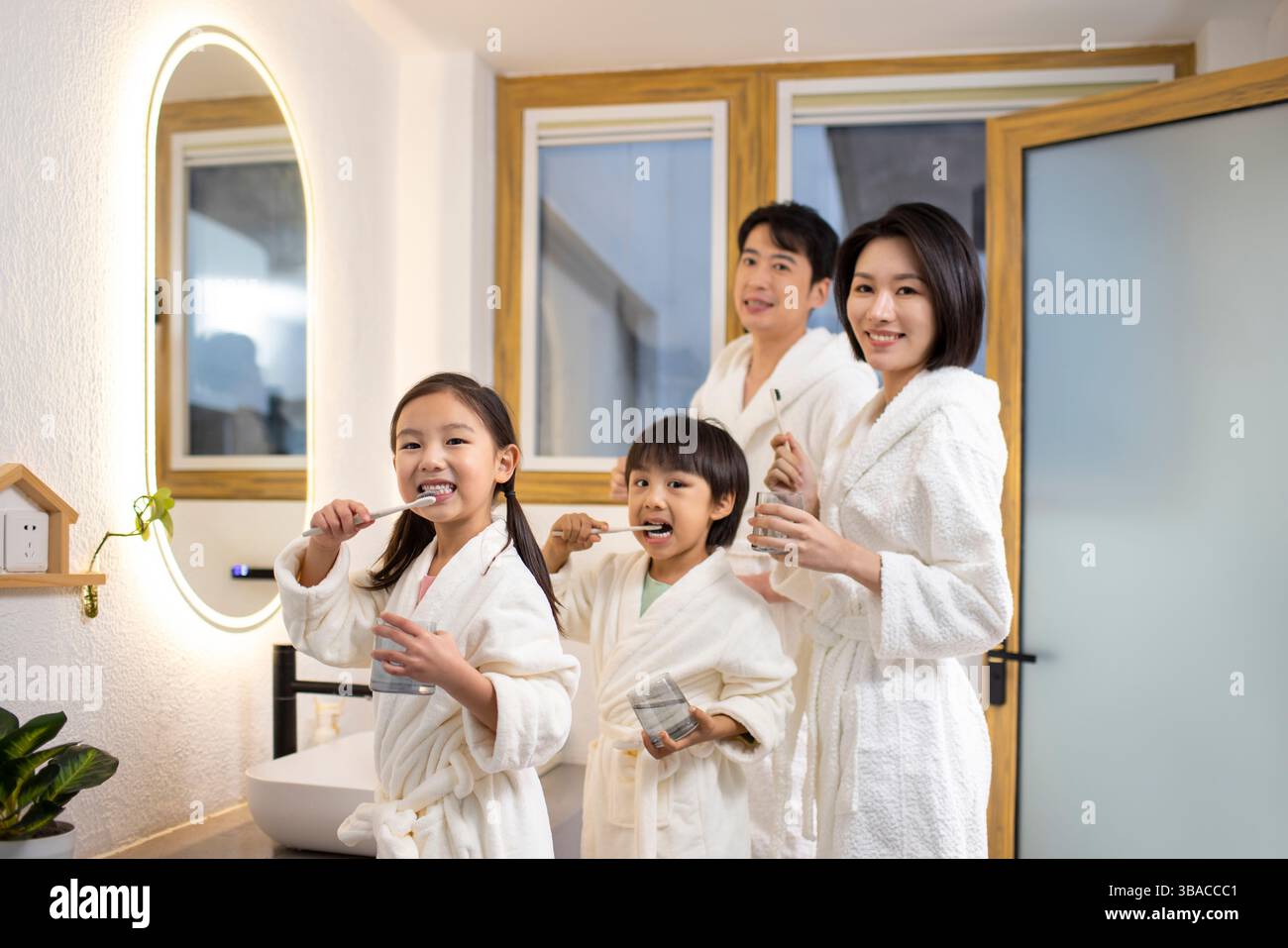 Happy young Chinese family brushing teeth Stock Photo - Alamy