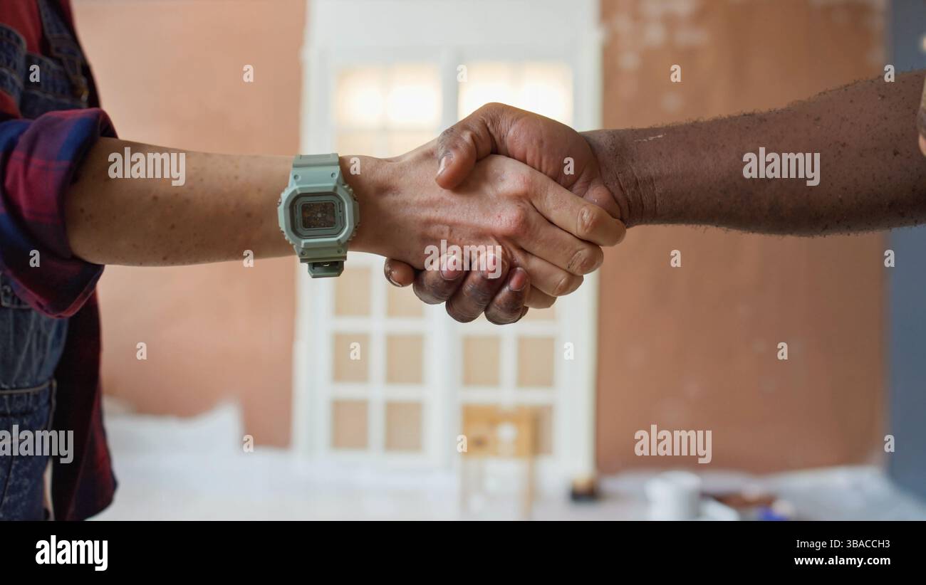 Friendly handshake between two individuals of different races in bright ...