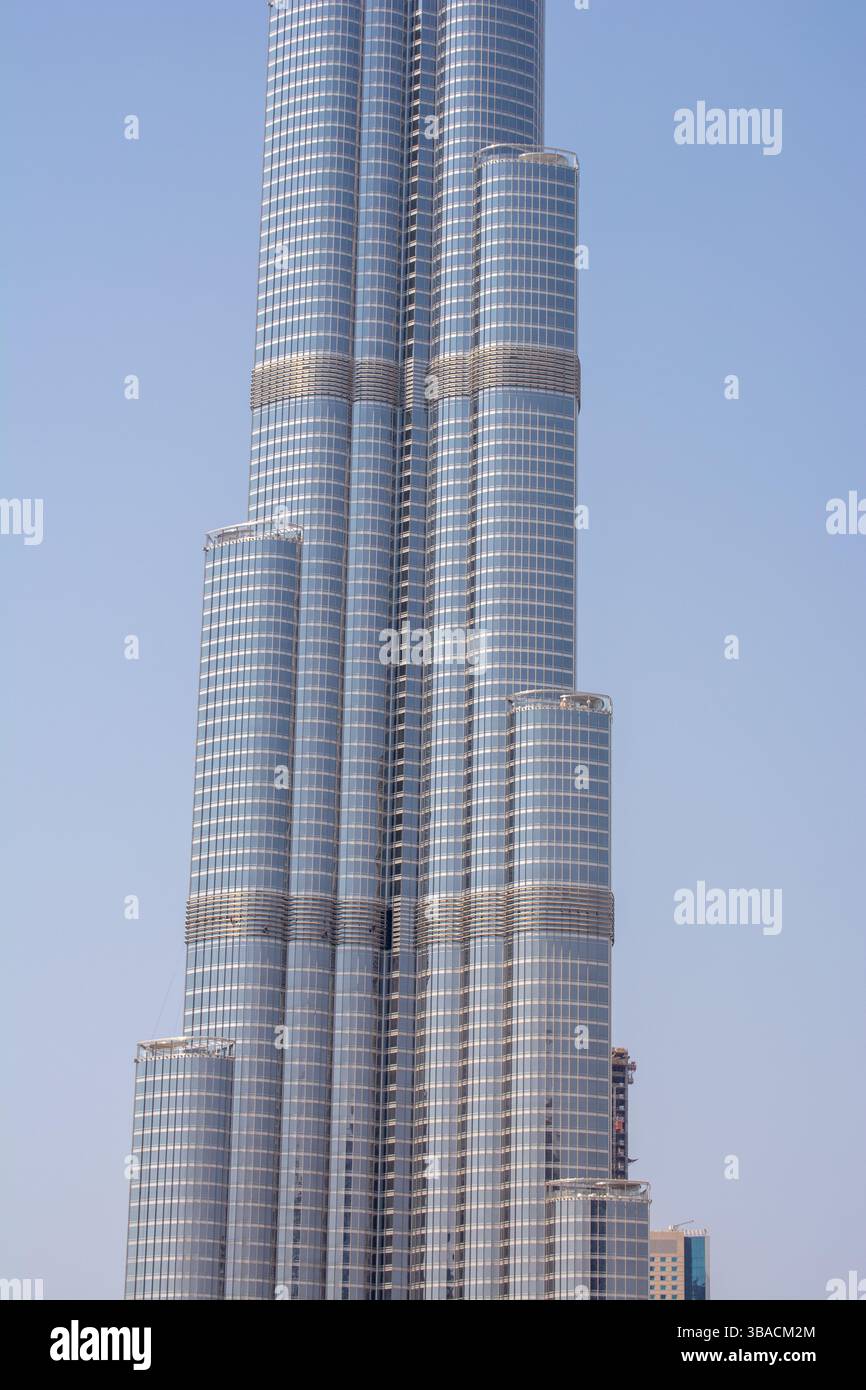 A close-up view of a modern skyscraper with a sleek glass facade ...