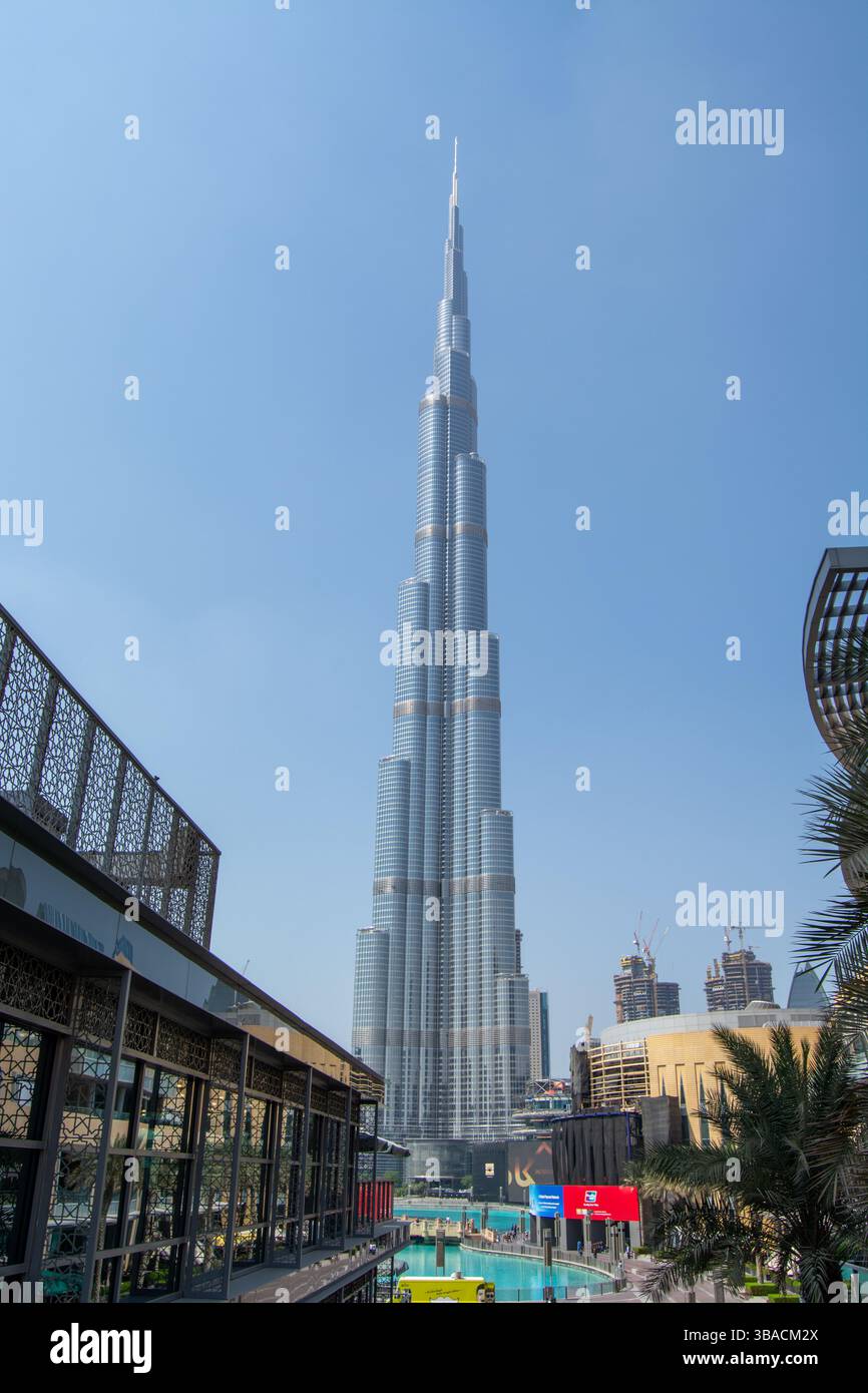 A tall skyscraper, the Burj Khalifa, towers over a modern urban ...
