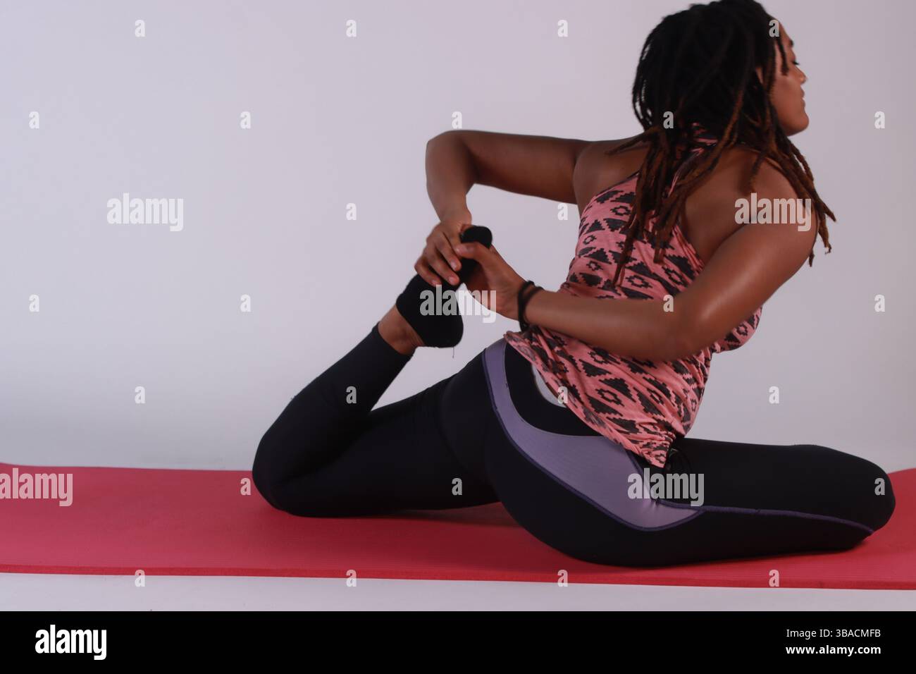 Black Afro-Caribbean woman with natural dreadlocks wearing fitness ...