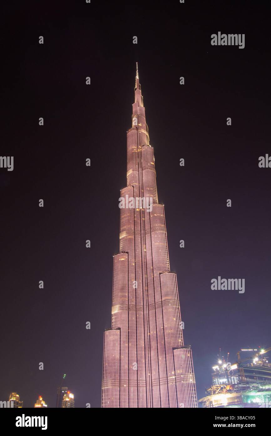 The Burj Khalifa illuminated at night, showcasing its towering height ...