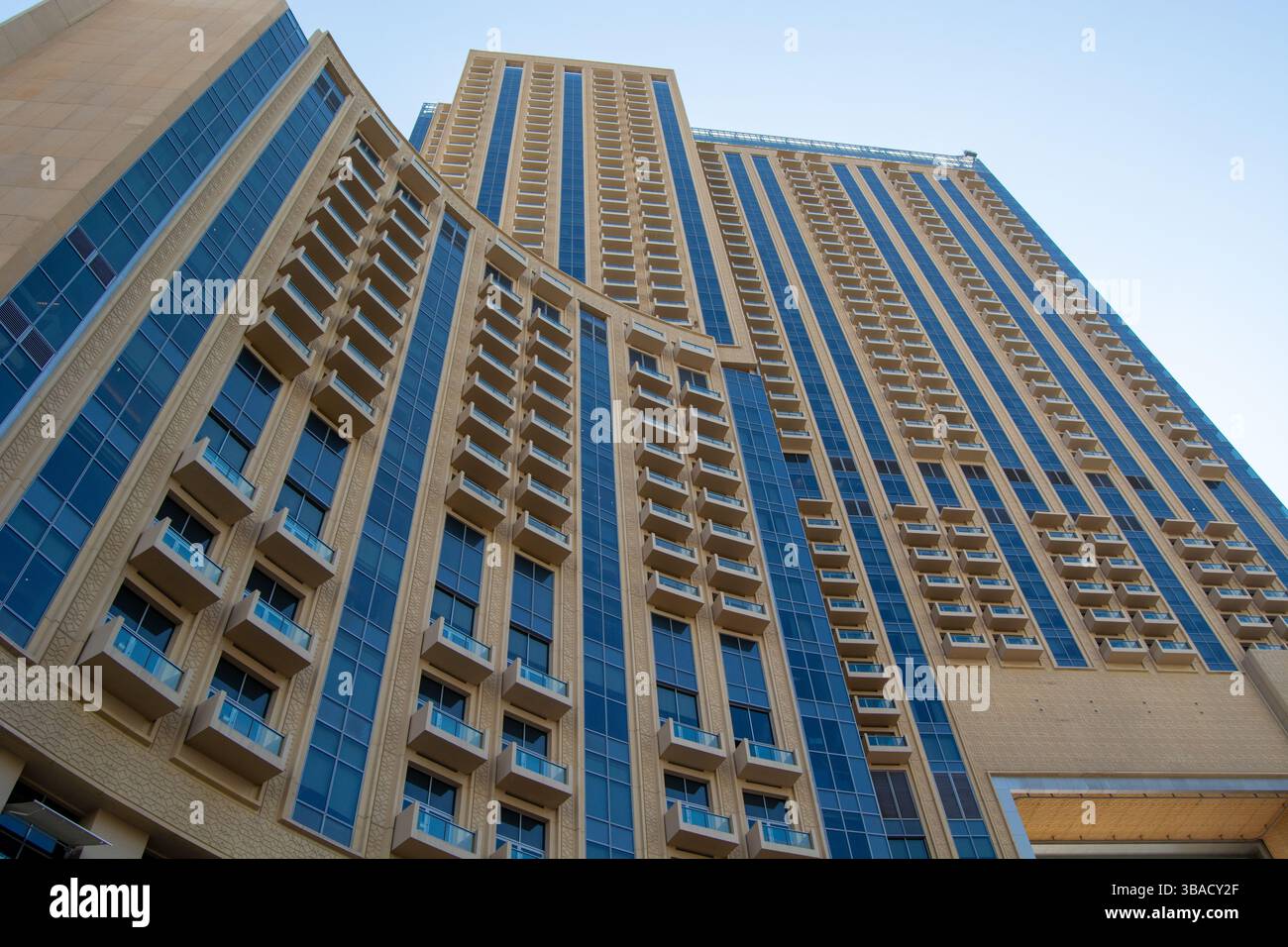 A modern high-rise building with a unique curved design, featuring ...