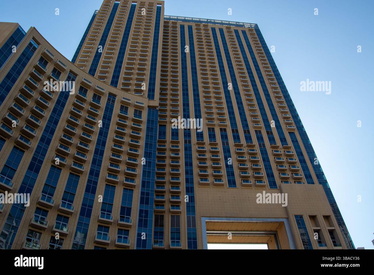 A tall modern building with a unique architectural design, featuring a ...