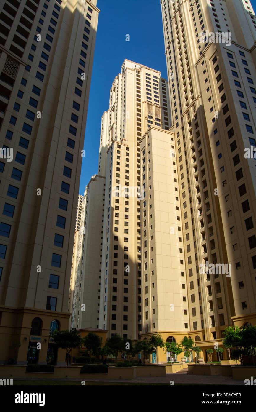 A view of tall residential buildings with a clear blue sky in the ...