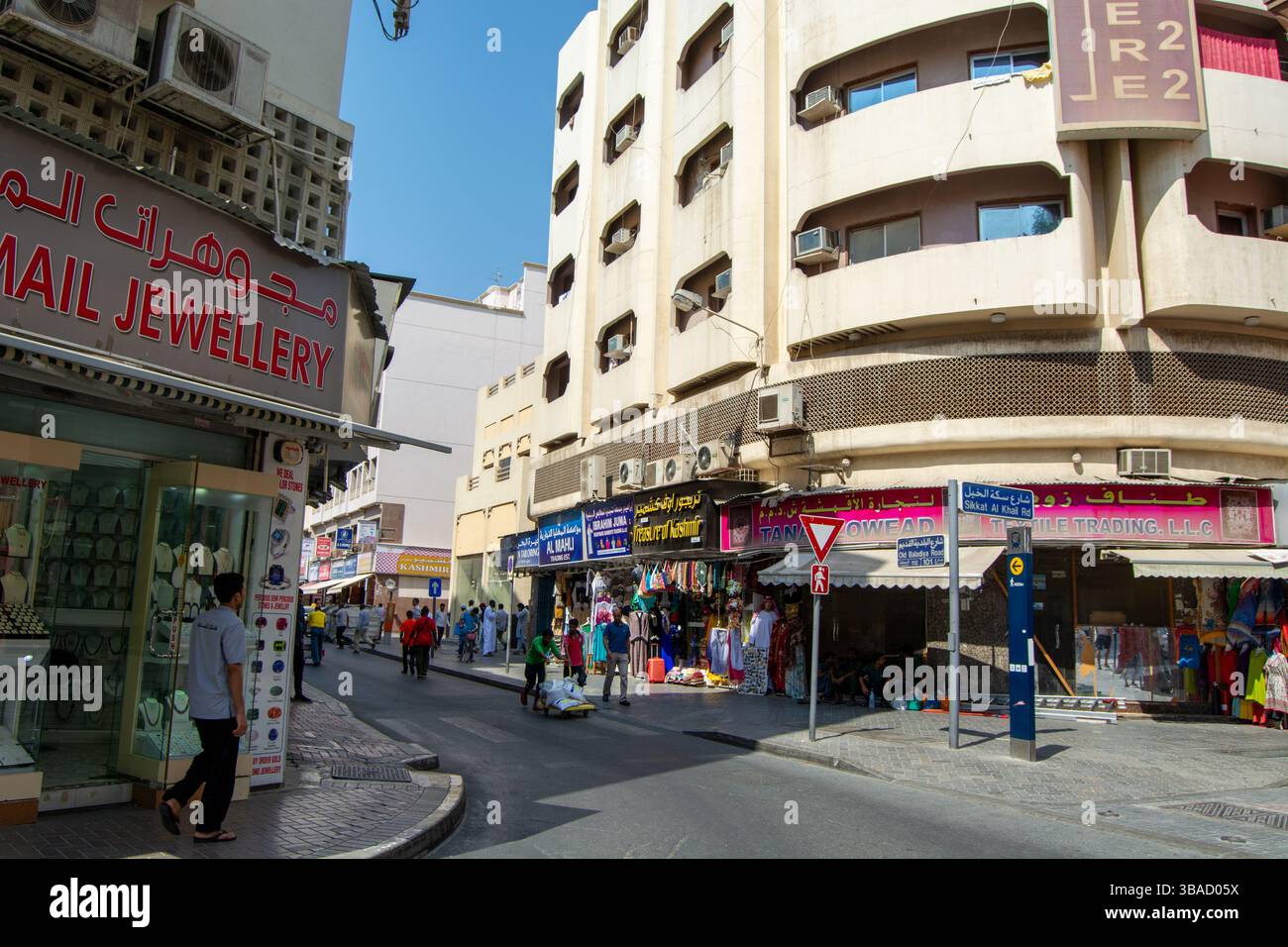 A bustling street scene in a Middle Eastern city, featuring shops with ...