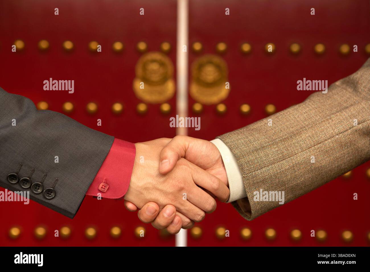 Chinese men shaking hands standing outdoors during daytime Stock Photo ...