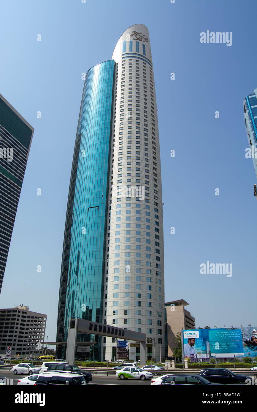 A tall, modern skyscraper with a sleek glass facade, reflecting the ...