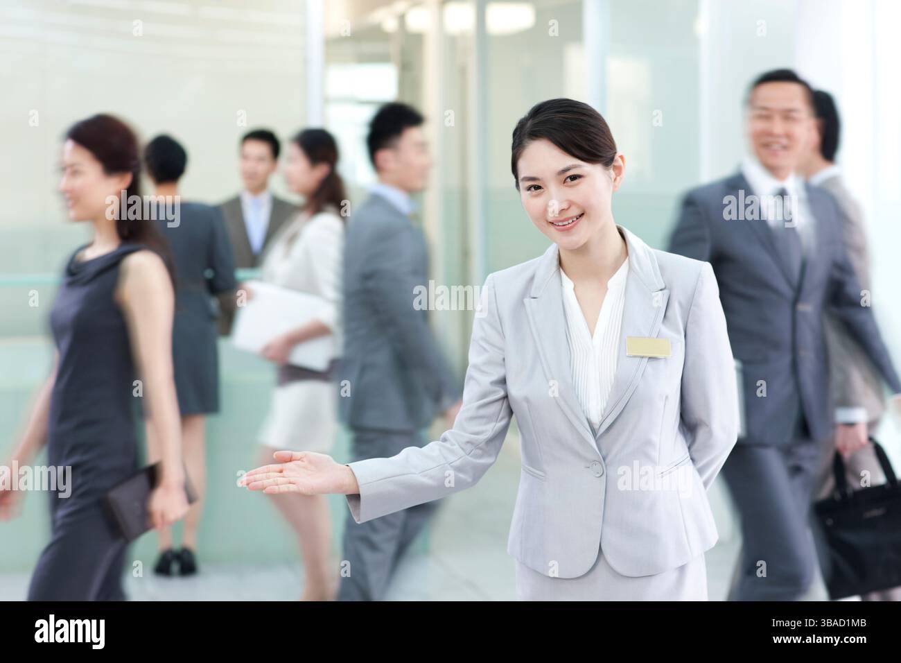 Chinese business persons at front desk Stock Photo - Alamy