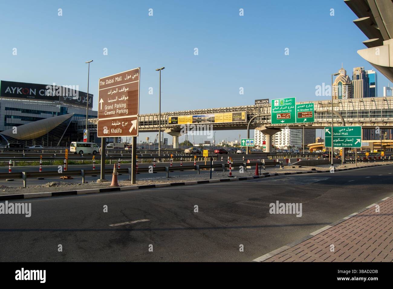 A busy urban intersection in Dubai with road signs indicating ...